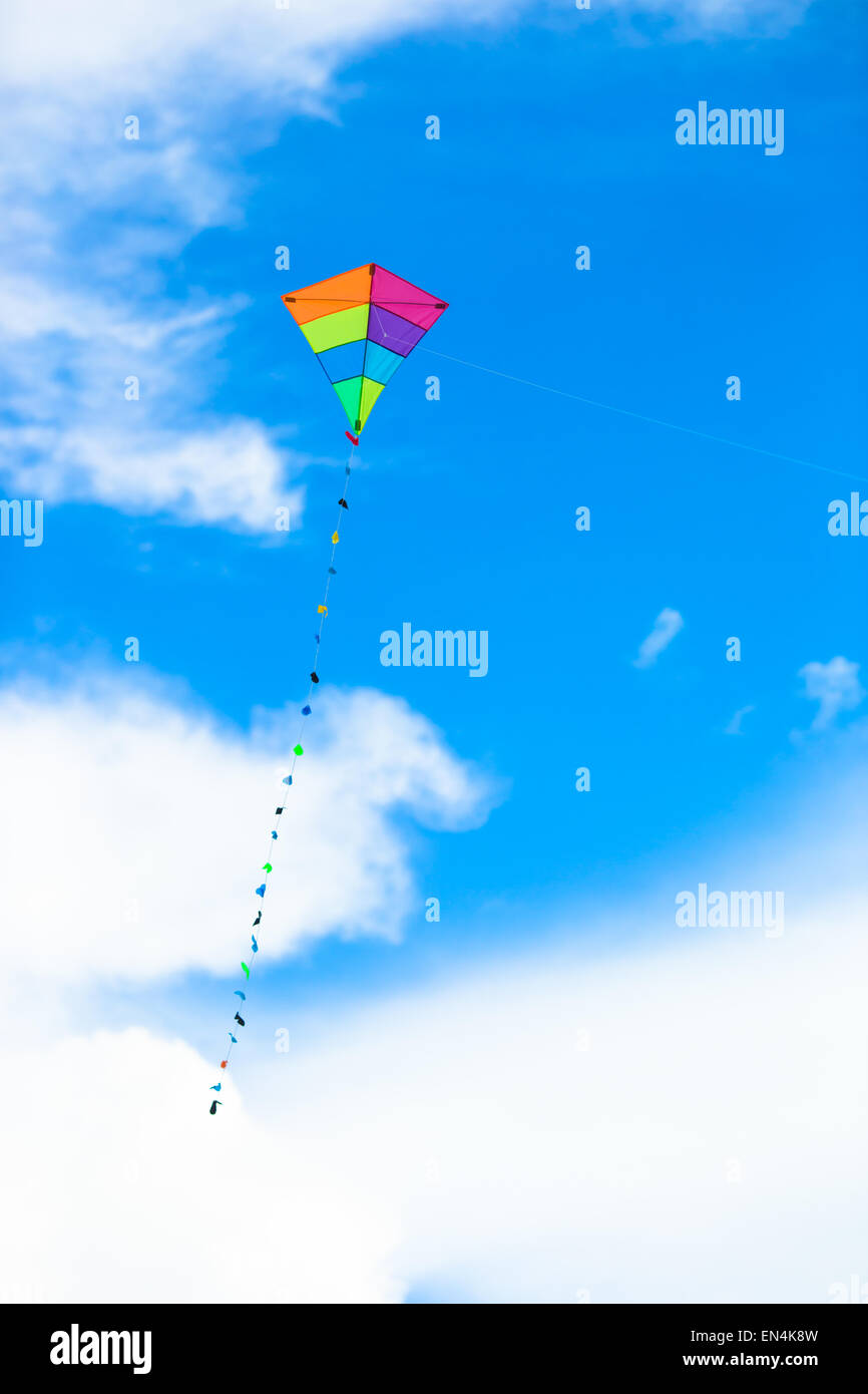 Colorful kite flying in the wind background blue sky Stock Photo - Alamy