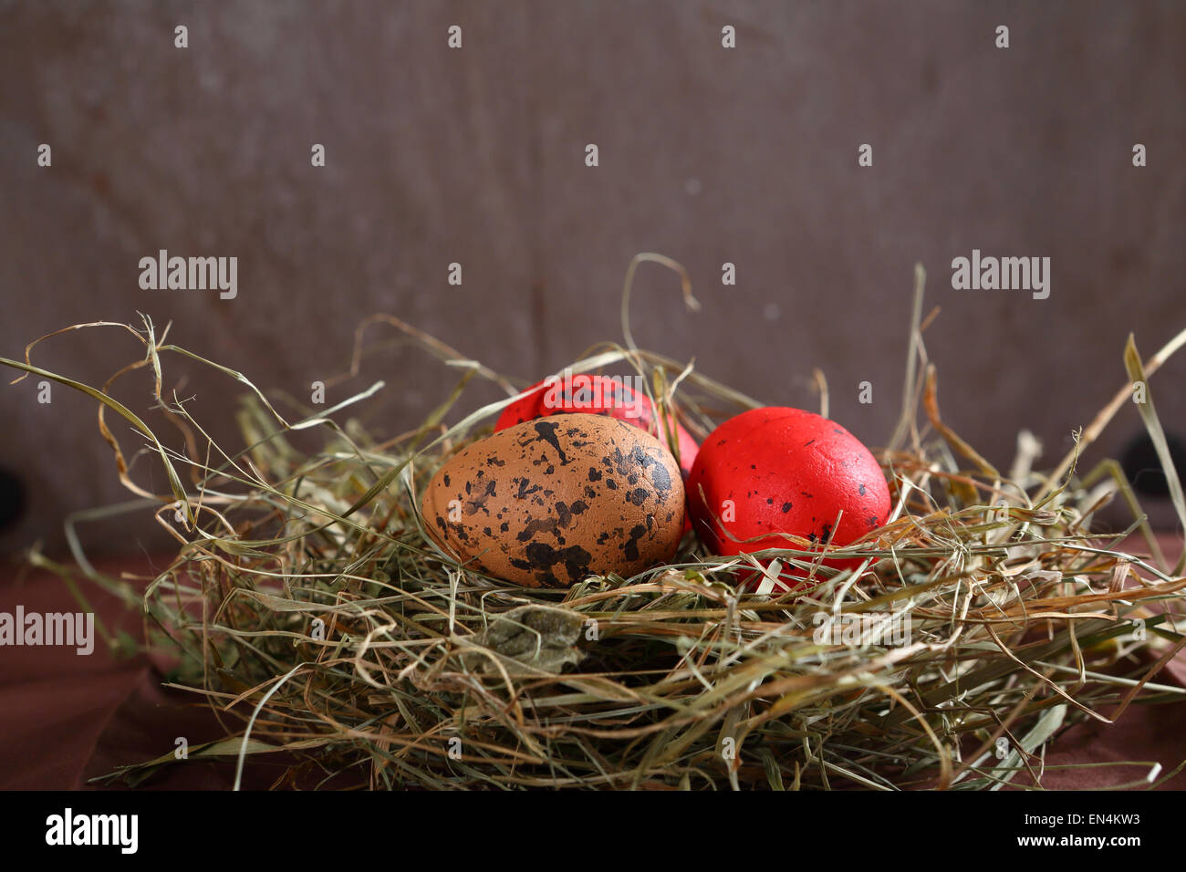 Colored eggs on the hay, food Stock Photo - Alamy