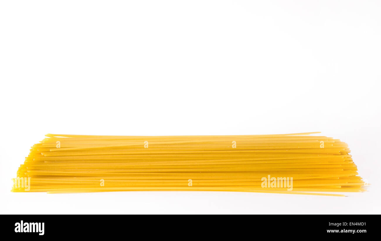 A portion of spaghetti, ready to cook, on white background Stock Photo ...