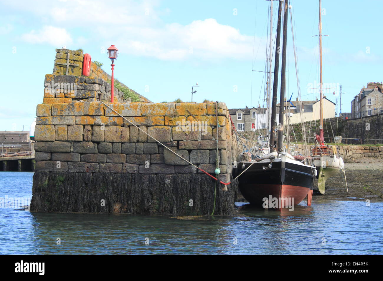 old lugger moored alongside stone granite quay in newlyn harbour on ...