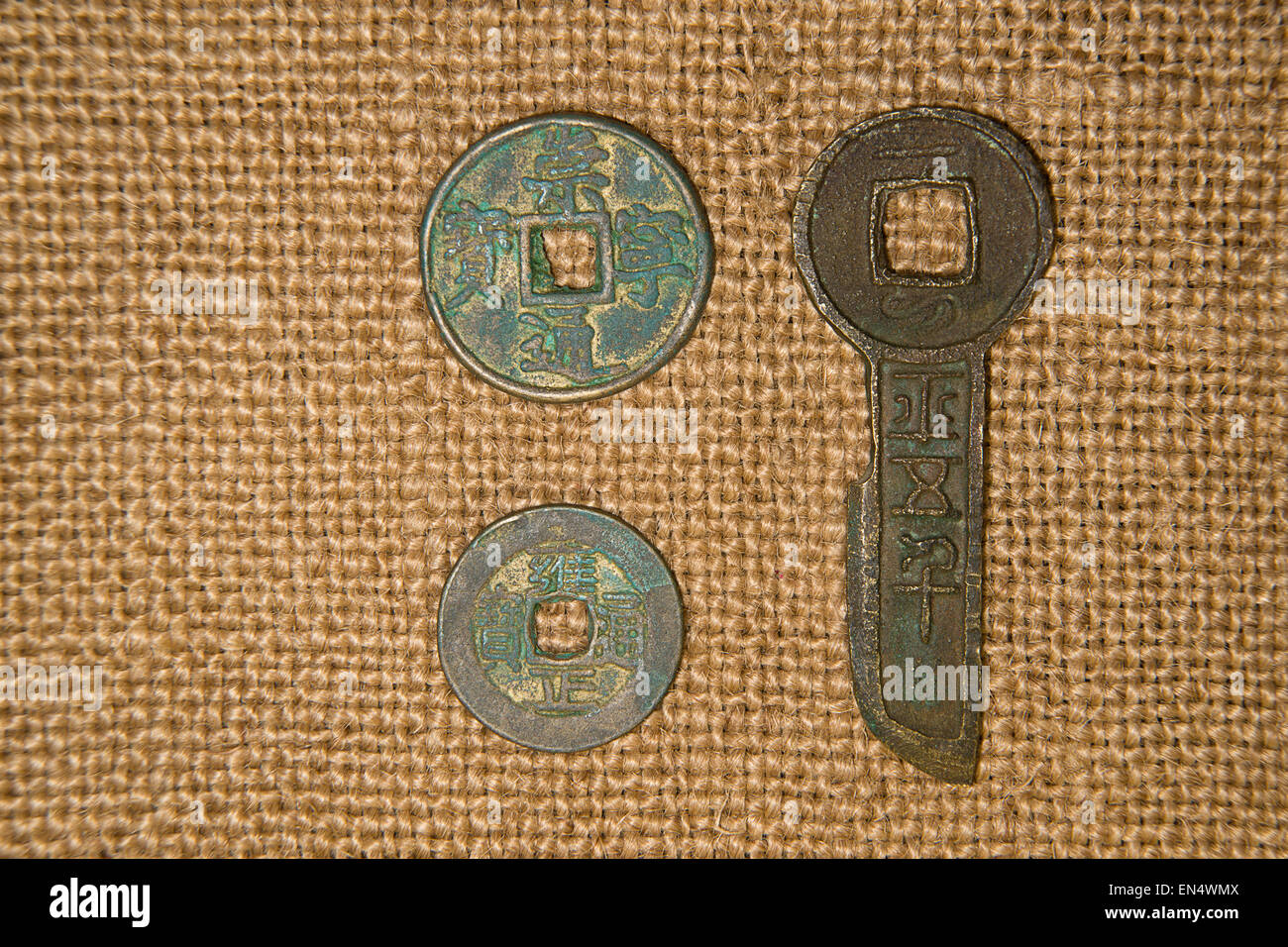 A lot antique bronze Chinese coins on old cloth Stock Photo - Alamy