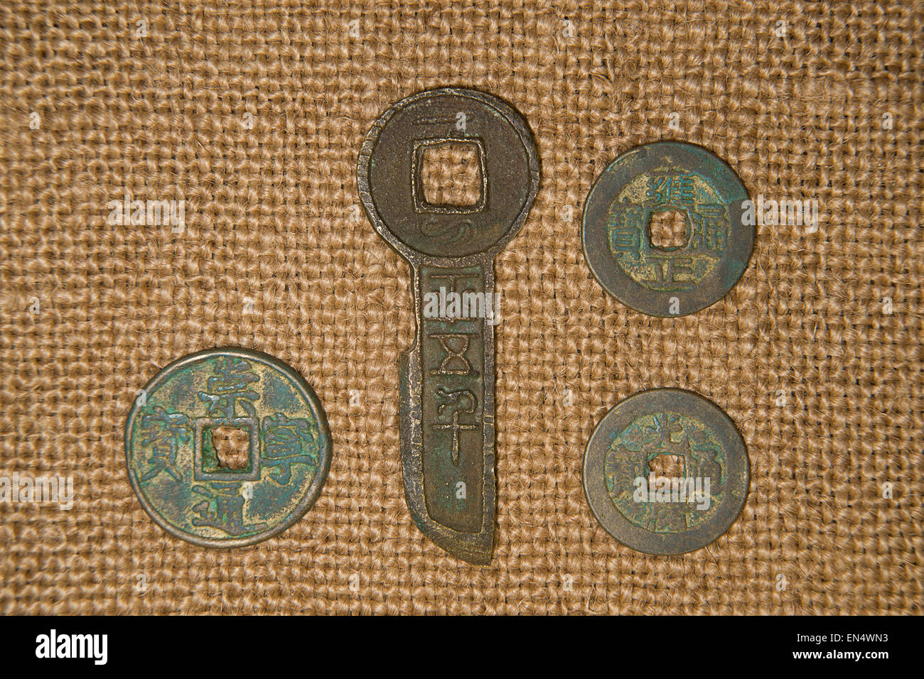 A lot antique bronze Chinese coins on old cloth Stock Photo - Alamy