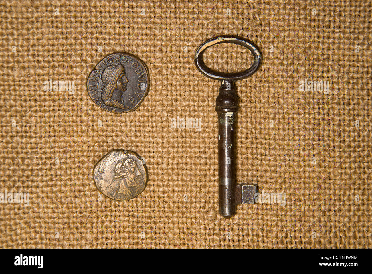Antique bronze coins and key on old cloth Stock Photo - Alamy