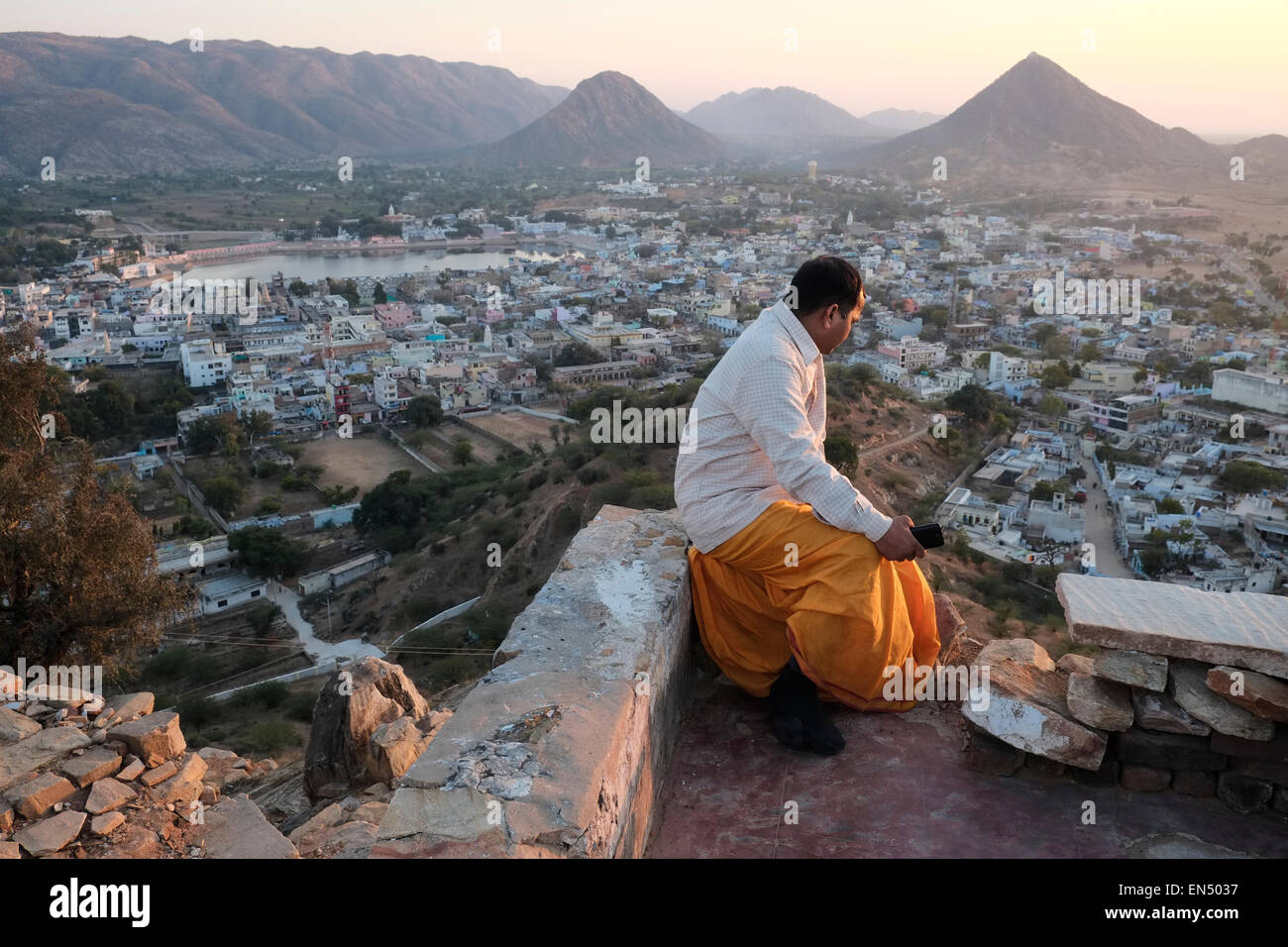 Priest from Gayatri temple overlooking Pushkar town below Stock Photo ...