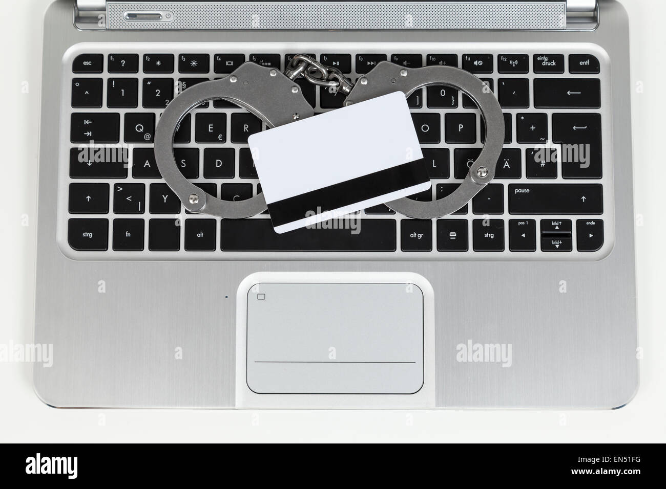credit card cheater with handcuff on laptop Stock Photo - Alamy