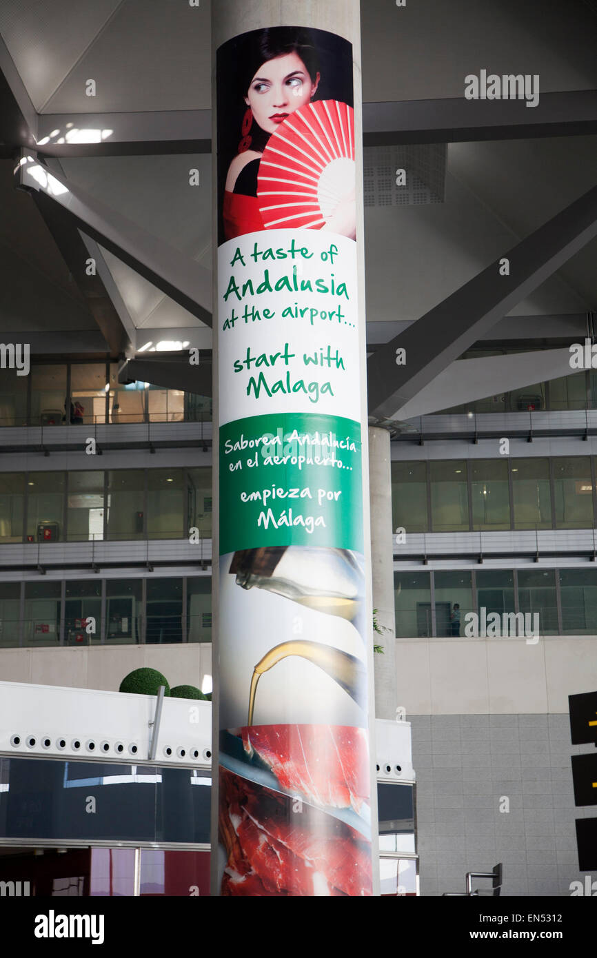 Tourist advertising poster on a building column at Malaga airport ...