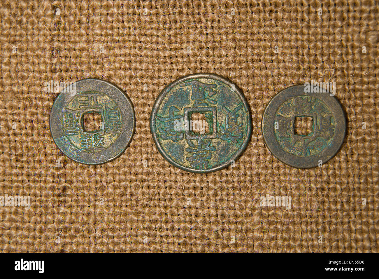 A lot antique bronze Chinese coins on old cloth Stock Photo - Alamy