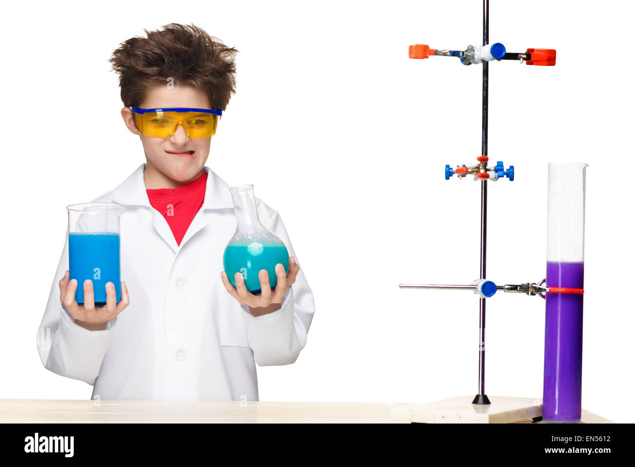 Little boy as chemist doing experiment with chemical fluid in the ...