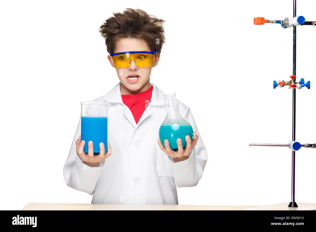 Little boy as chemist doing experiment with chemical fluid in the ...