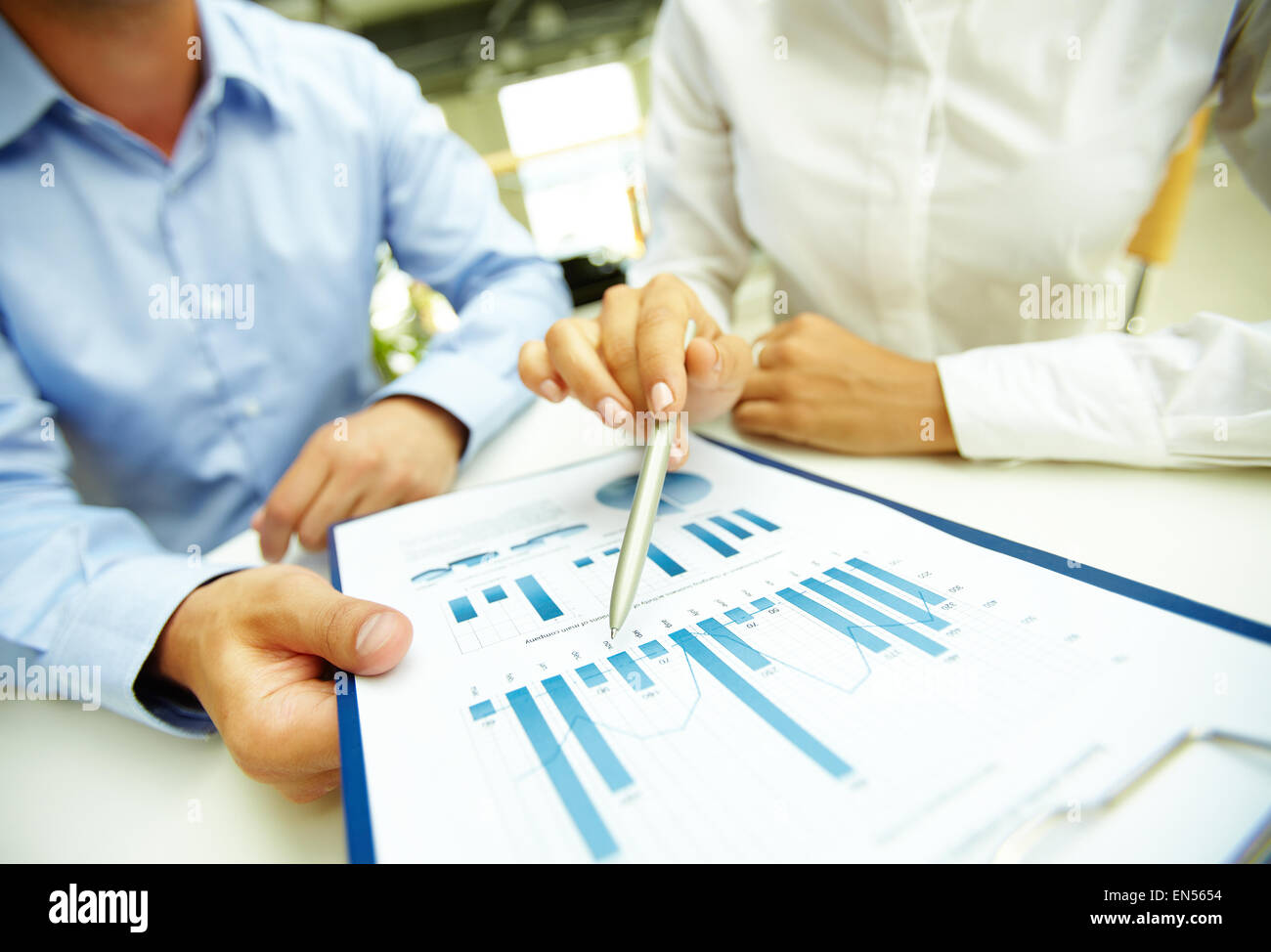 Female hand with pen pointing at document Stock Photo - Alamy