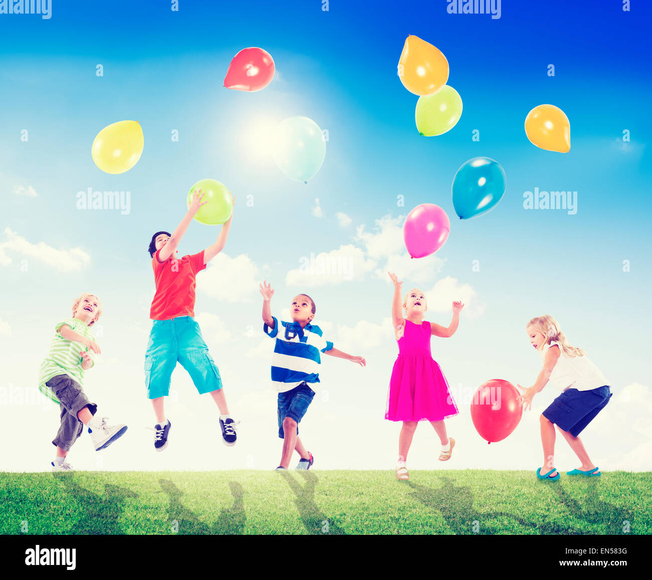 Multi-Ethnic Children Outdoors Playing Balloons Together Stock Photo ...