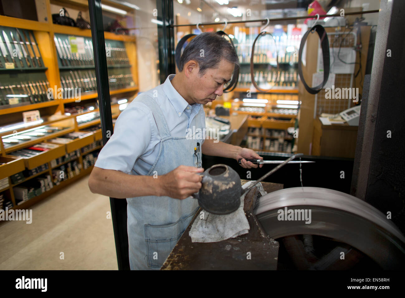 Man sharpening knives in hi-res stock photography and images - Alamy