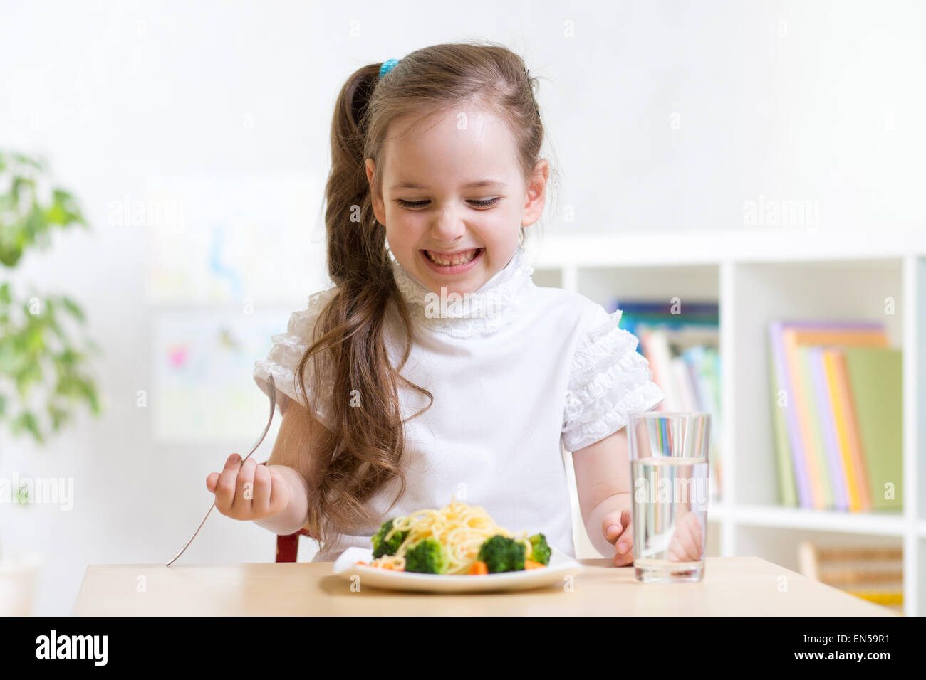 joyful child eating healthy food at home Stock Photo - Alamy