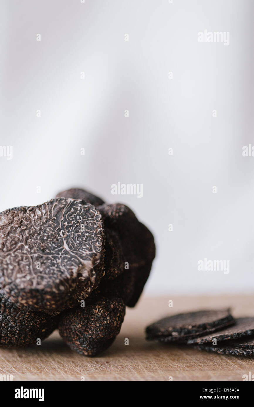 Whole black truffle with slices Stock Photo - Alamy