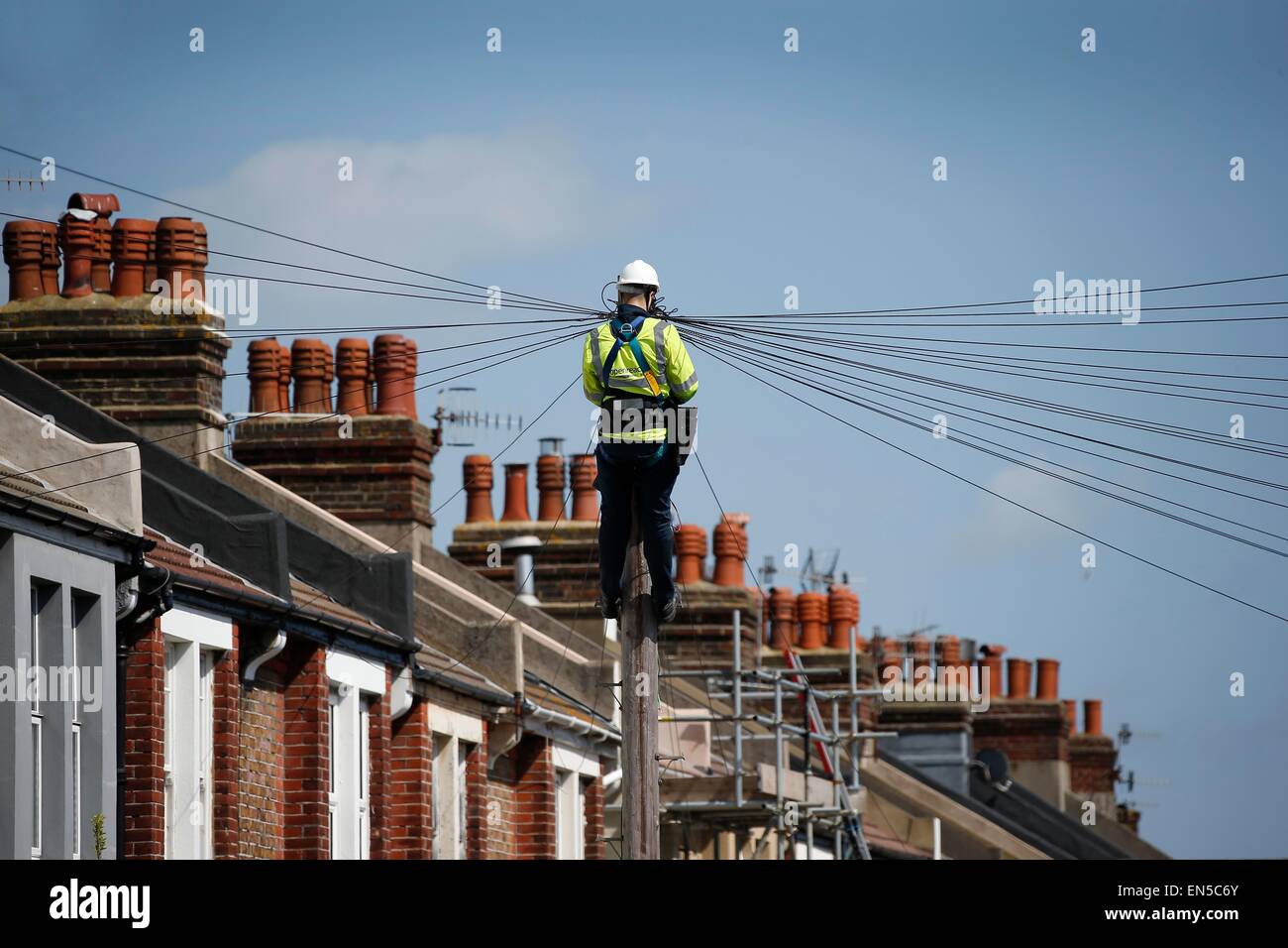 A BT Engineer working up a telegraph poll in a residential street in ...