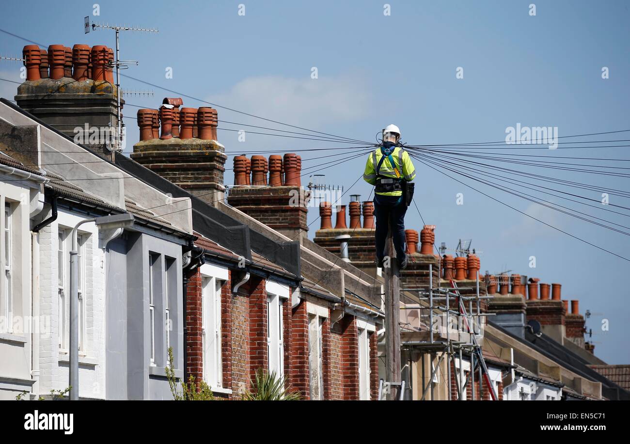A BT Engineer working up a telegraph poll in a residential street in ...