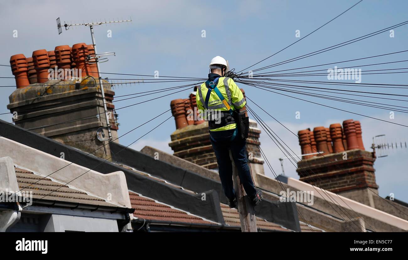 A BT Engineer working up a telegraph poll in a residential street in ...