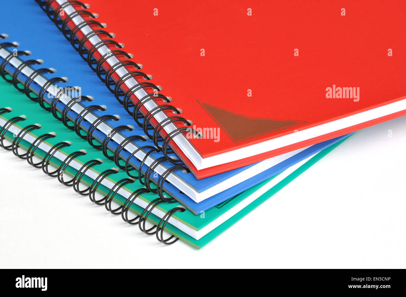 Corner of three color rectangular notebooks Stock Photo - Alamy