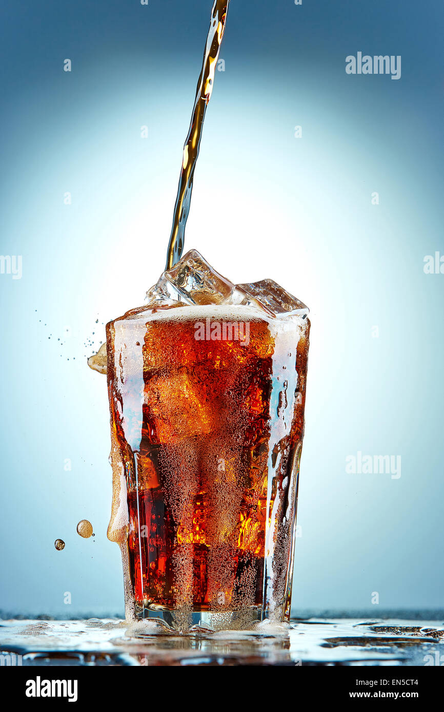 Cola pouring in a glass Stock Photo - Alamy