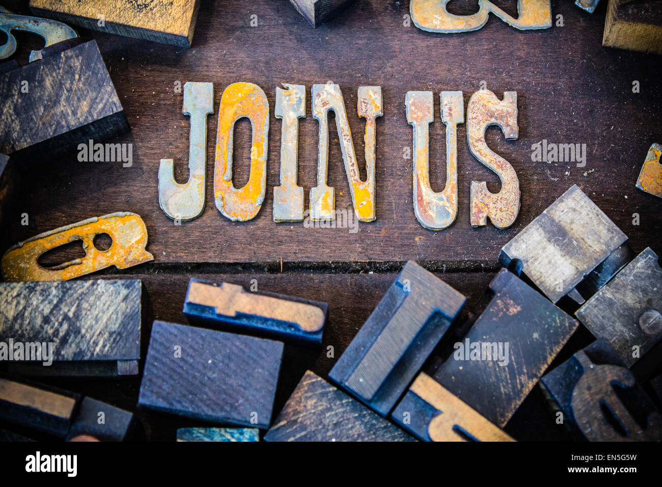 The words JOIN US written in rusted metal letters surrounded by vintage ...