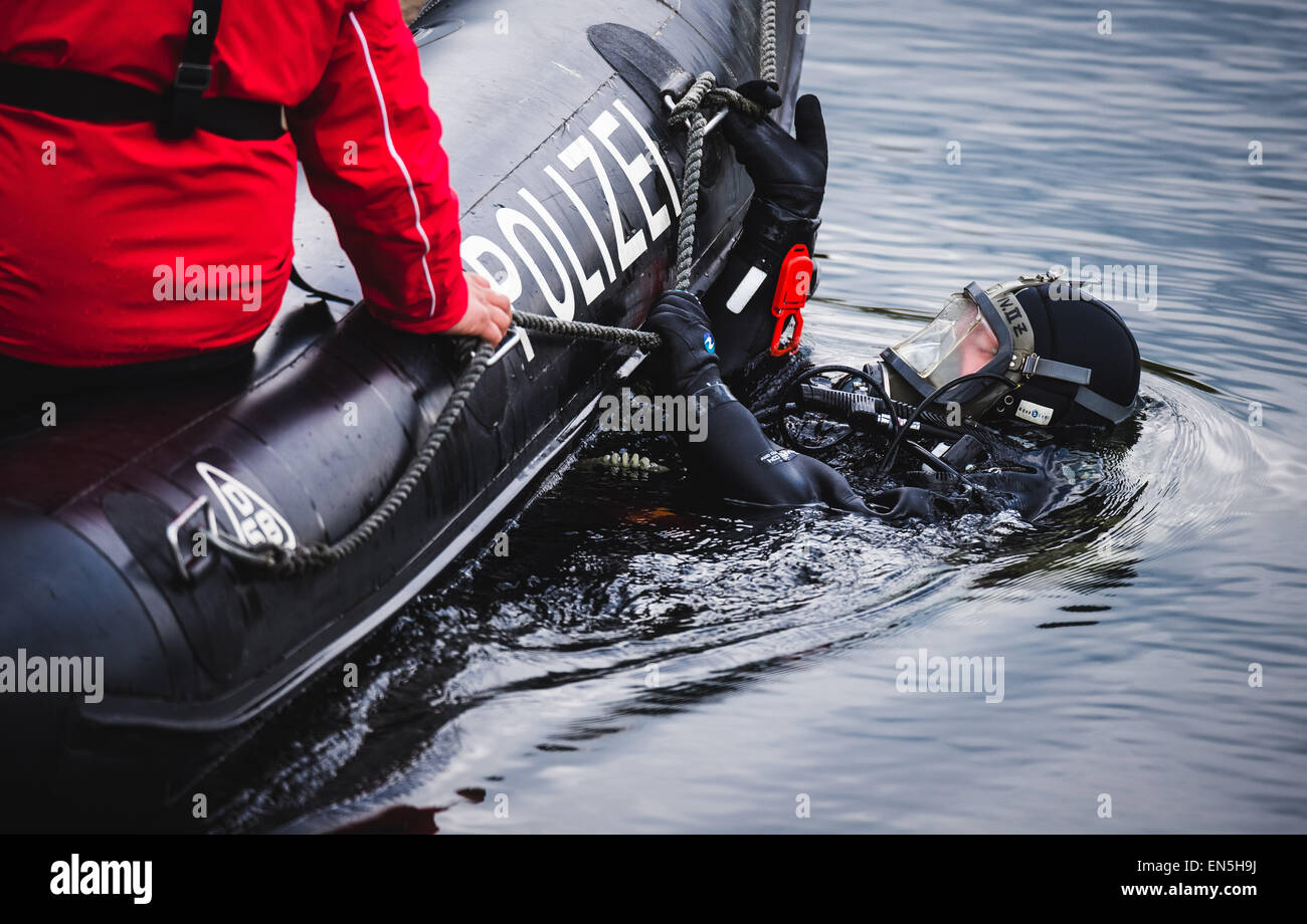 A police diver holds on a inflatable dinghy in the dam Pirk, Germany ...