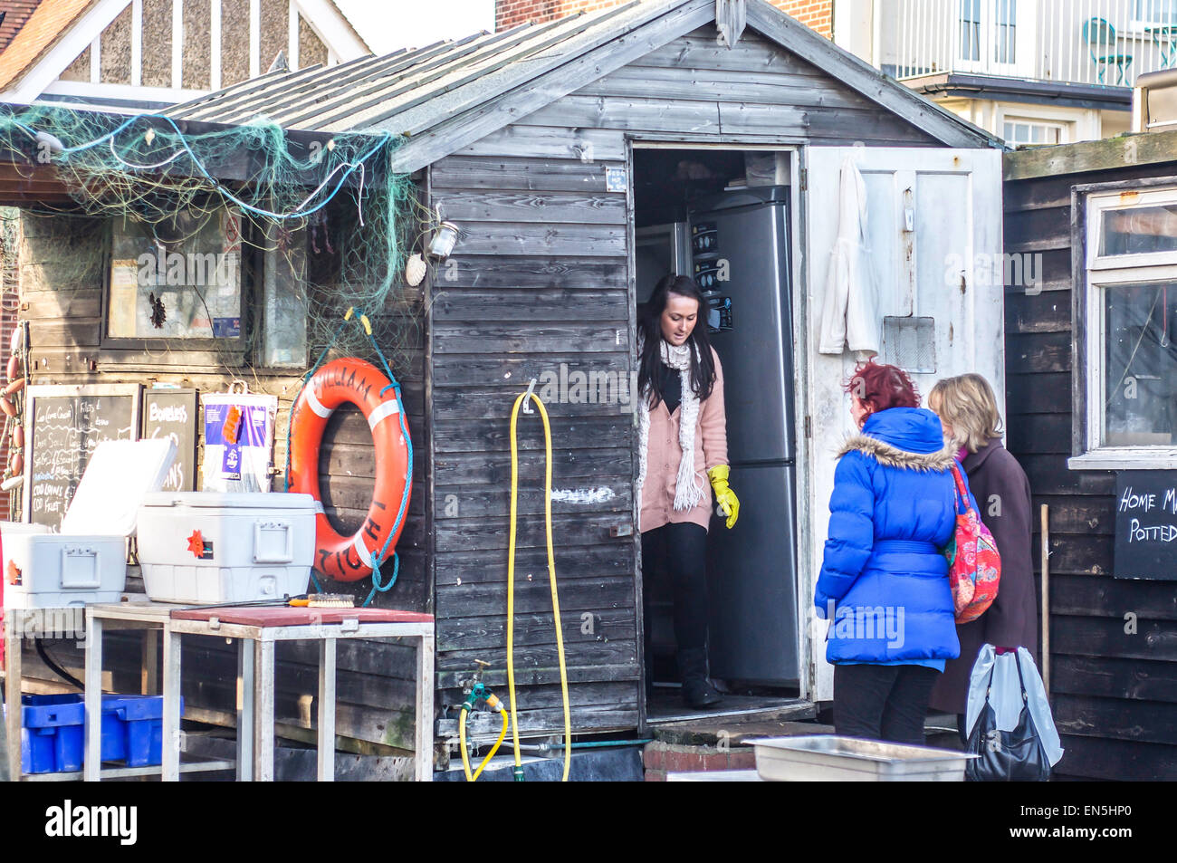 A fresh fish vendor sells her products from a small seaside shack in ...