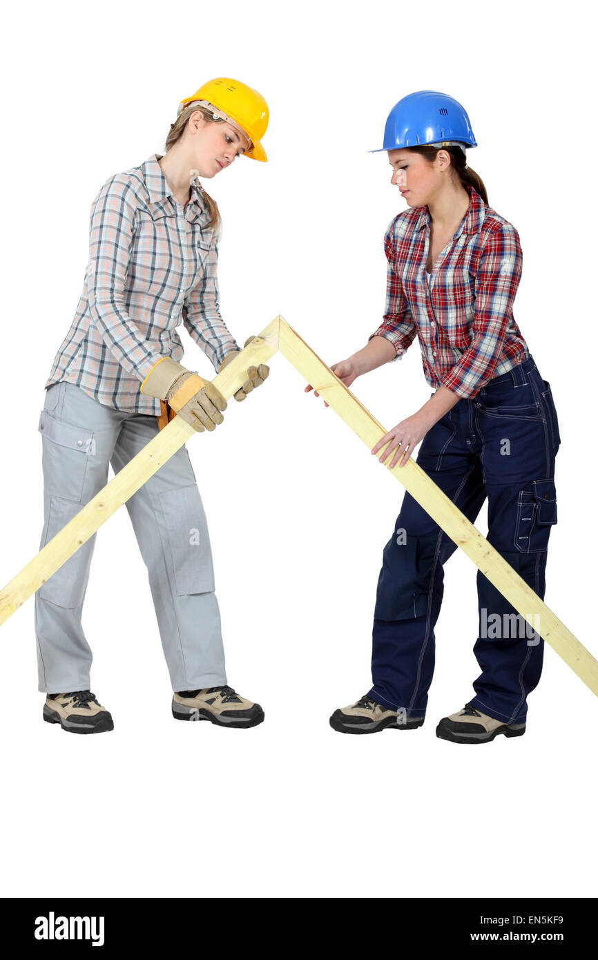 Female builders with a wooden apex Stock Photo - Alamy