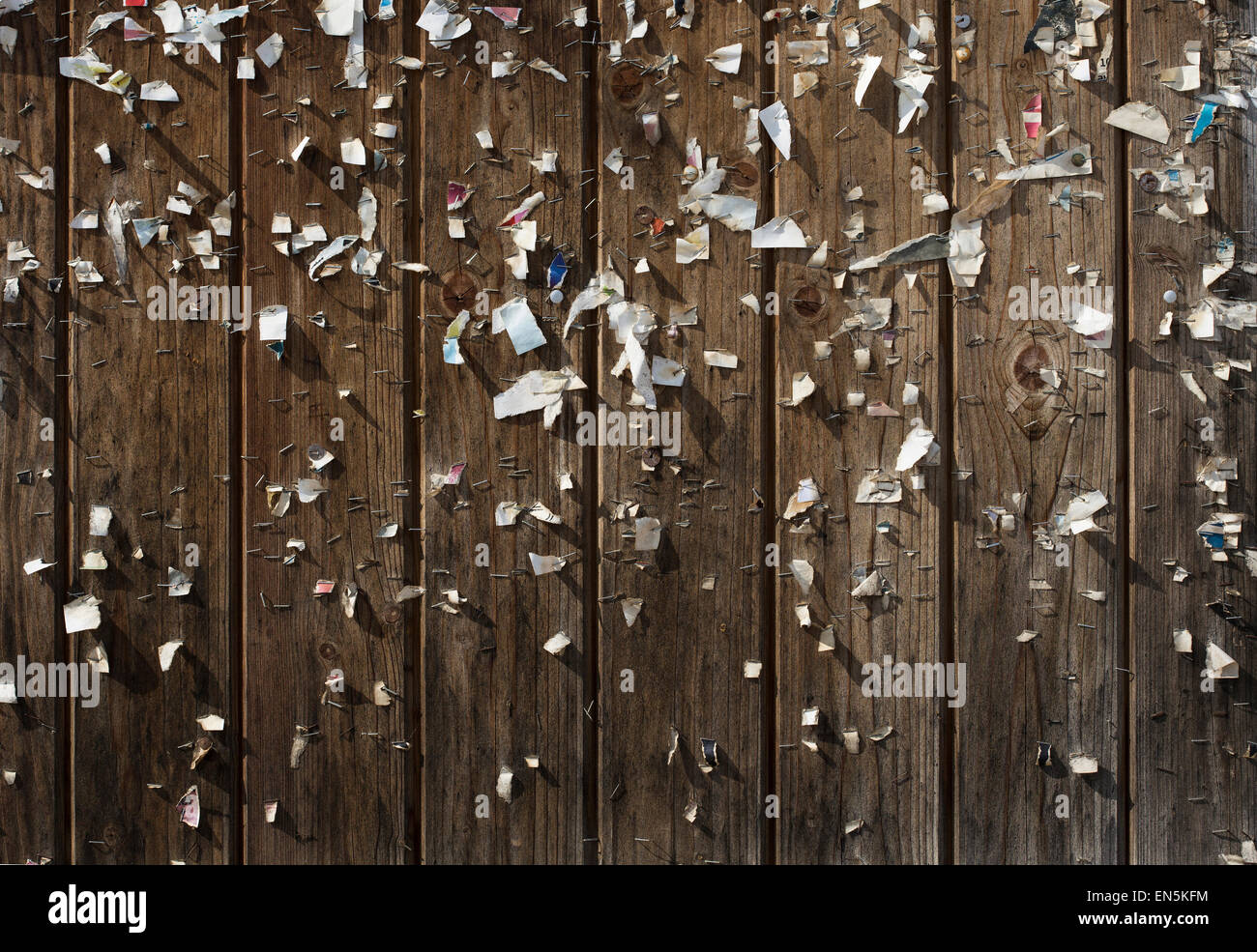 Pieces of paper on a billboard Stock Photo - Alamy