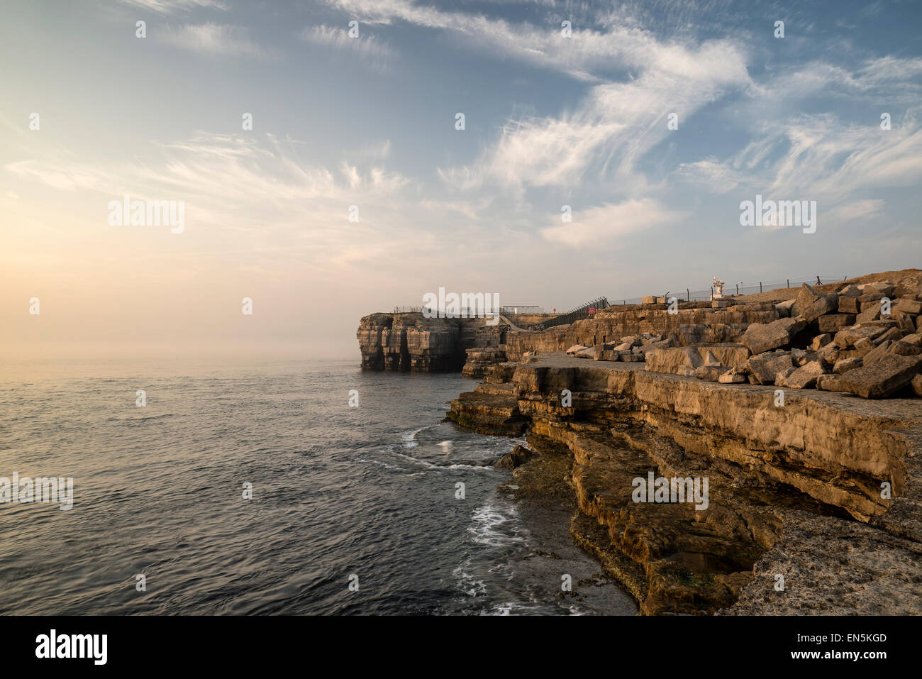 Rocky cliff landscape with sunset over ocean Stock Photo - Alamy