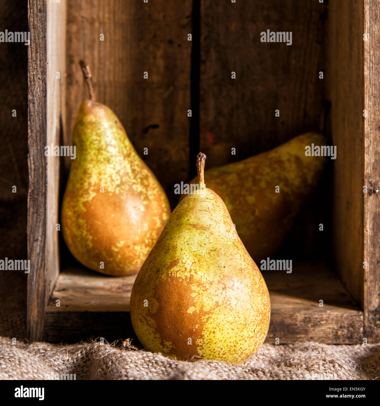 Pears in rustic setting with wooden box and hessian sack Stock Photo ...