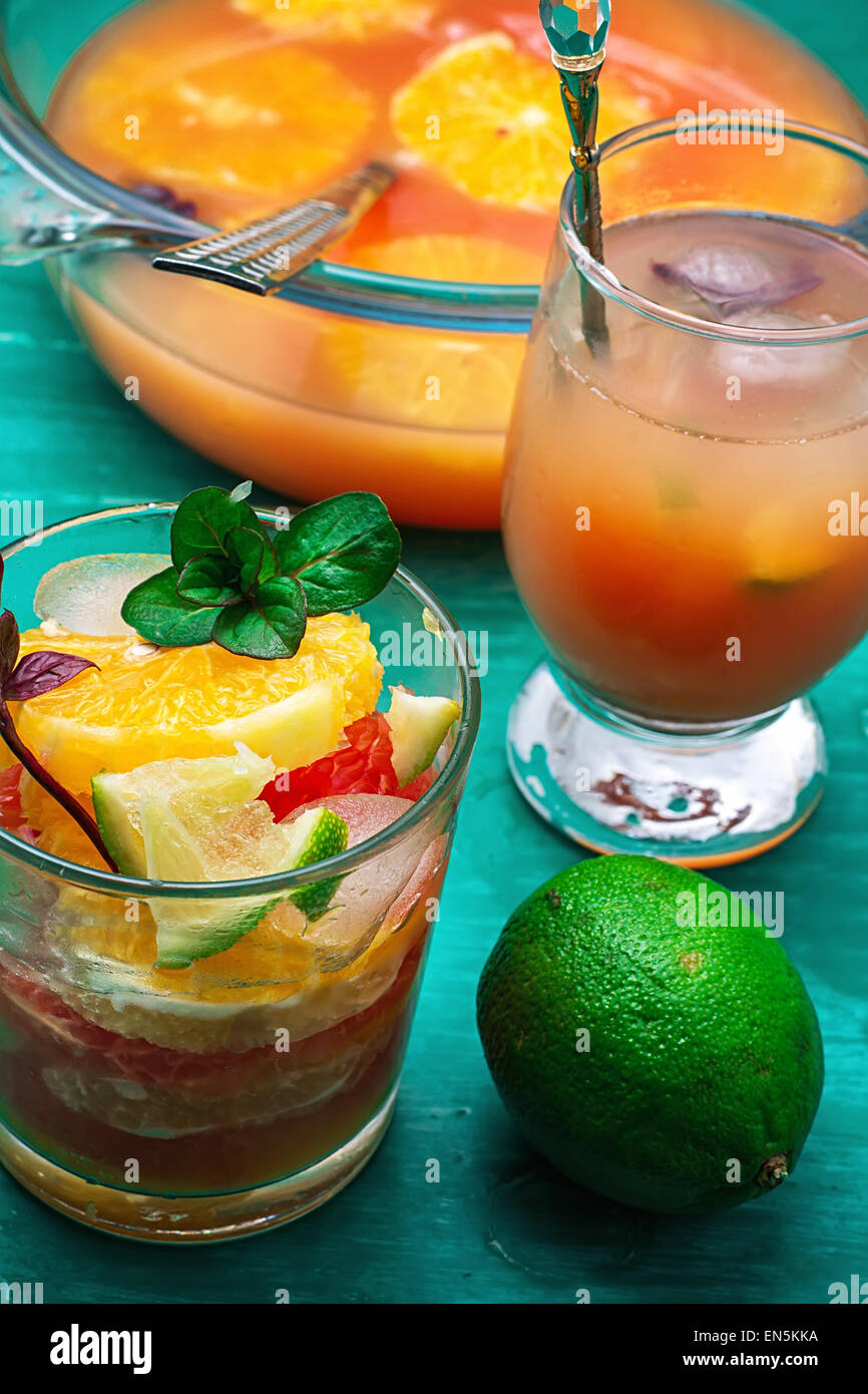 fresh juice from oranges,kiwi and grapefruit on turquoise wooden ...