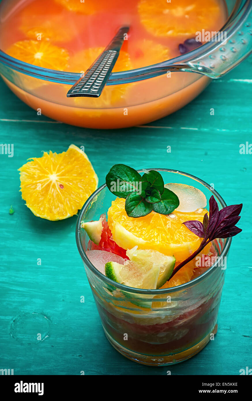 fresh juice from oranges,kiwi and grapefruit on turquoise wooden ...