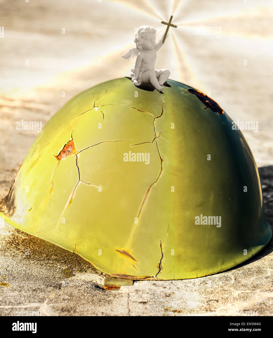 angel sitting on a helmet, used in war Stock Photo - Alamy
