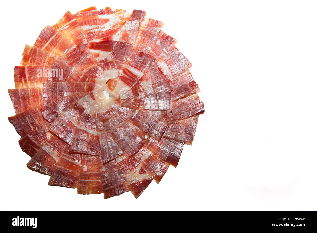 Circle made of spanish cured iberico ham slices. Isolated over white ...