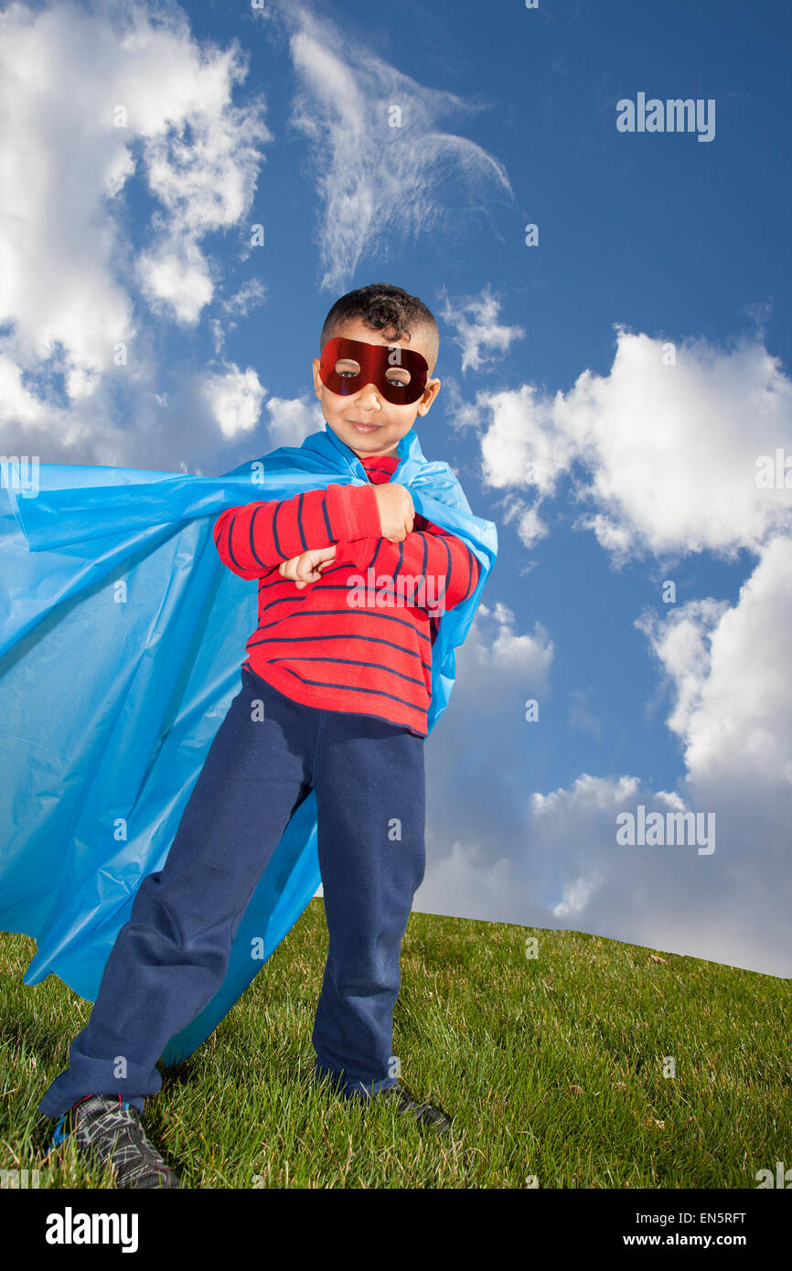 little boy superhero against blue sky Stock Photo - Alamy