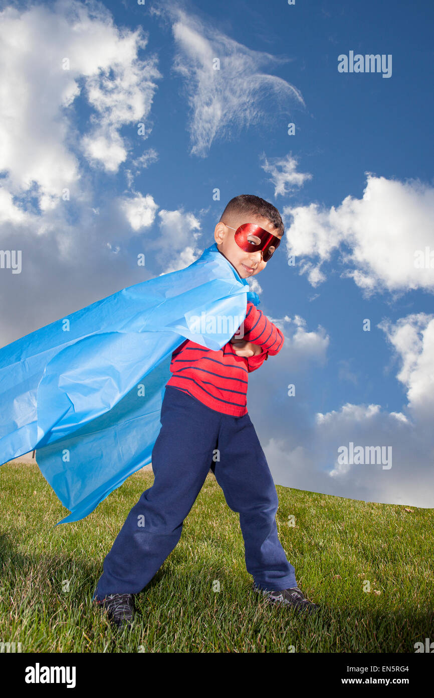 little boy superhero against blue sky Stock Photo - Alamy