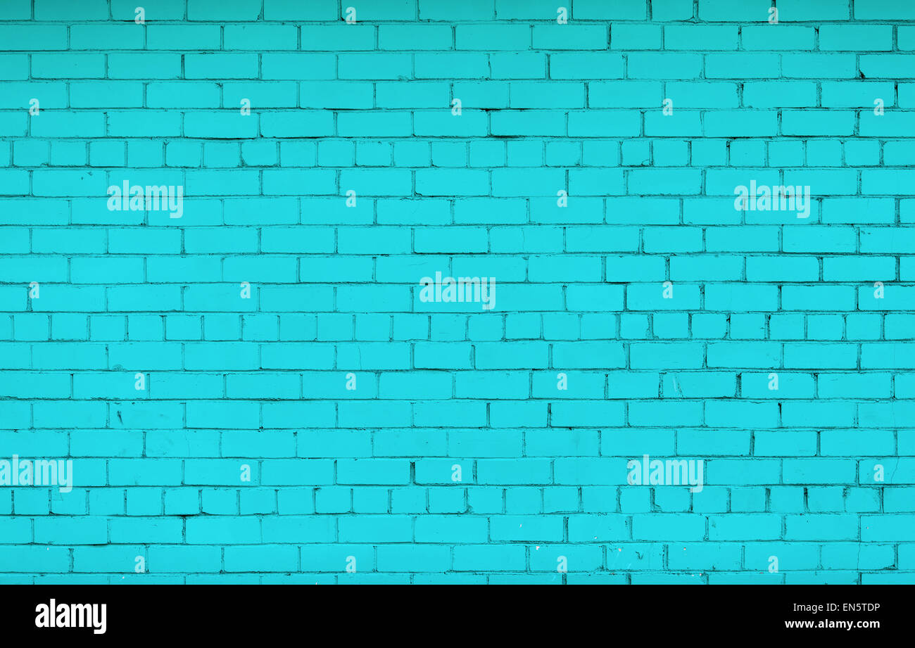 Brick wall painted in bright turquoise color. The texture of the ...