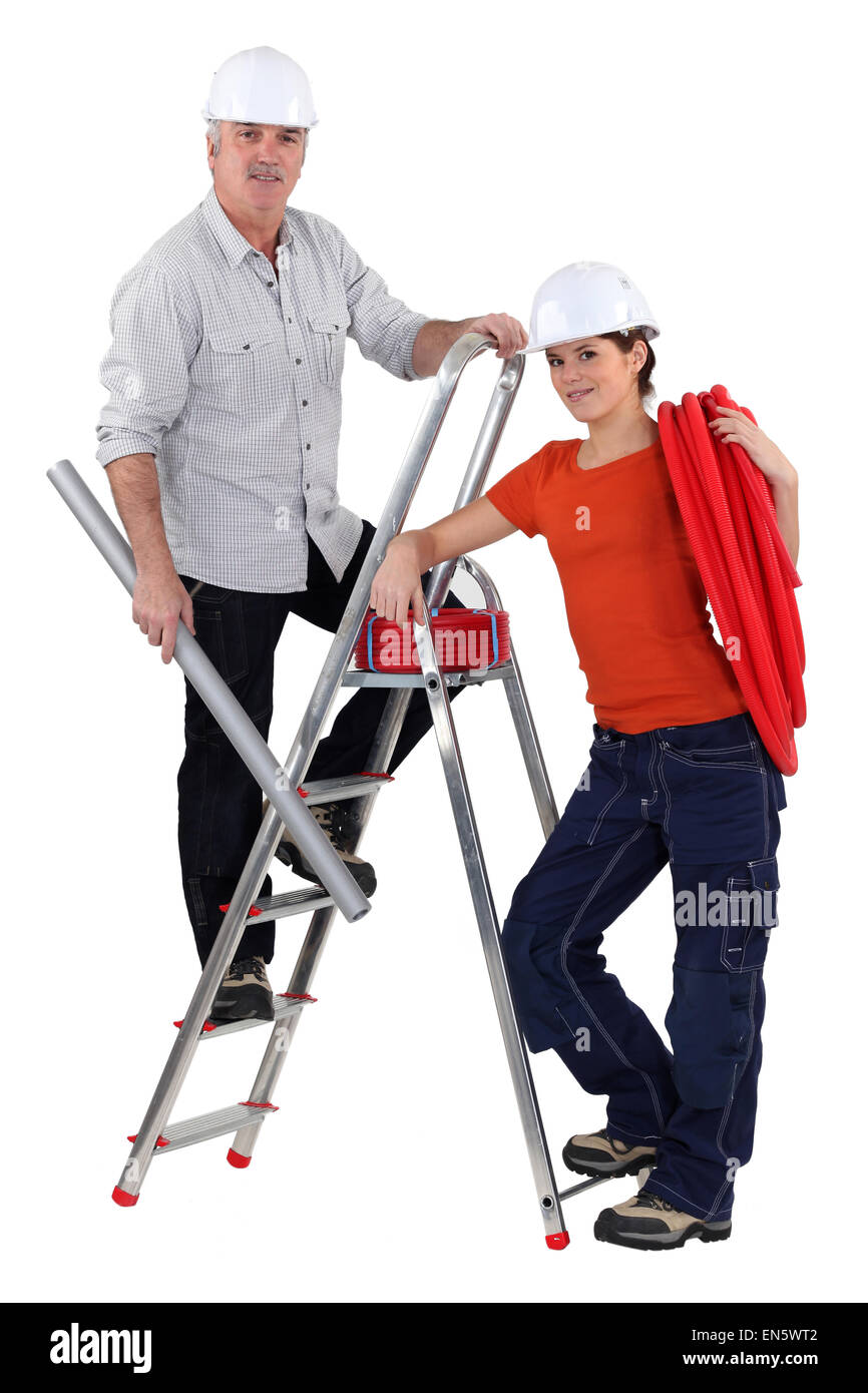Two electrician installing wiring Stock Photo - Alamy