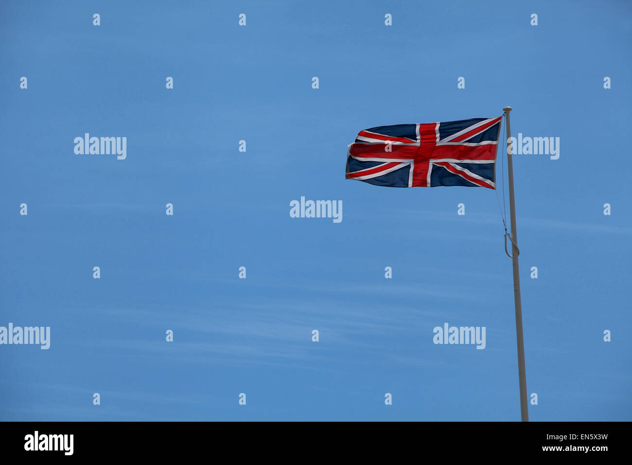 Union Flag flying against a blue sky with copy space Stock Photo - Alamy