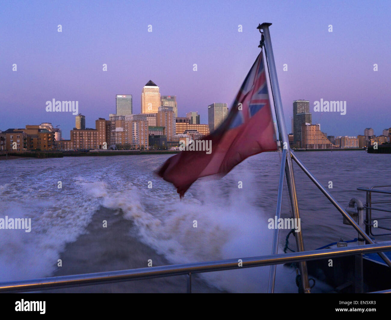 Thames Clipper River boat flying traditional red ensign flag departing ...