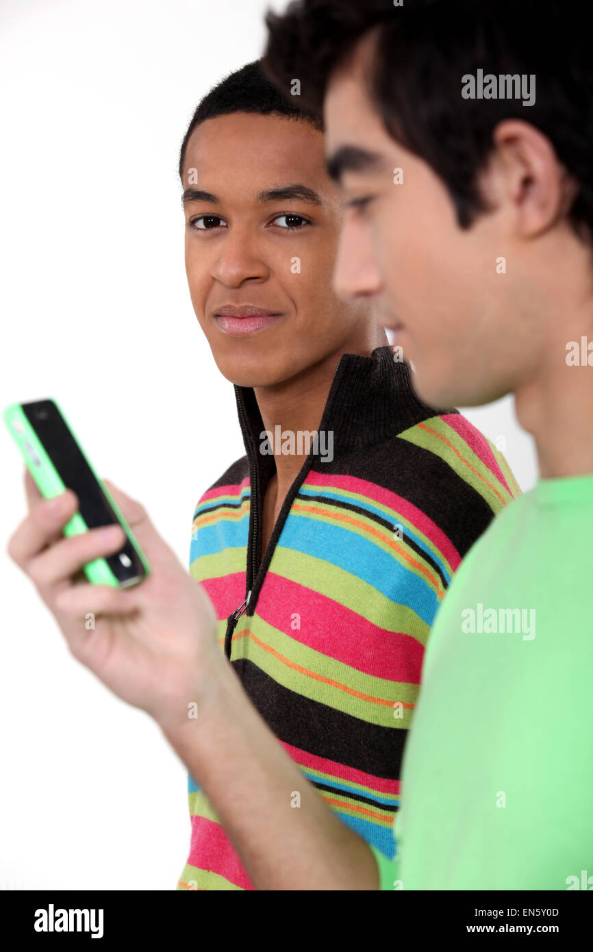 Two young men with cellphone Stock Photo - Alamy