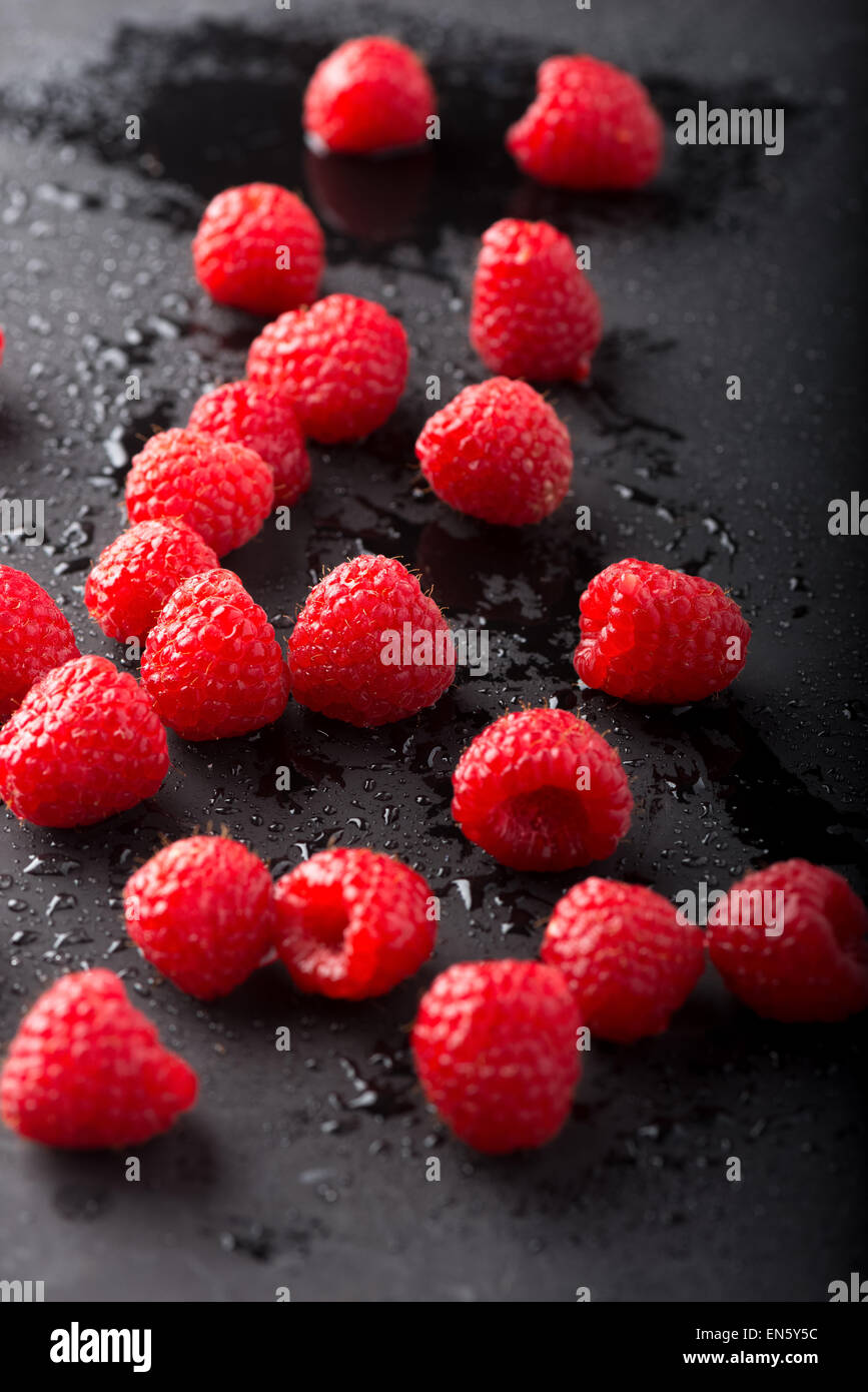 Wet raspberries set on black slate Stock Photo - Alamy