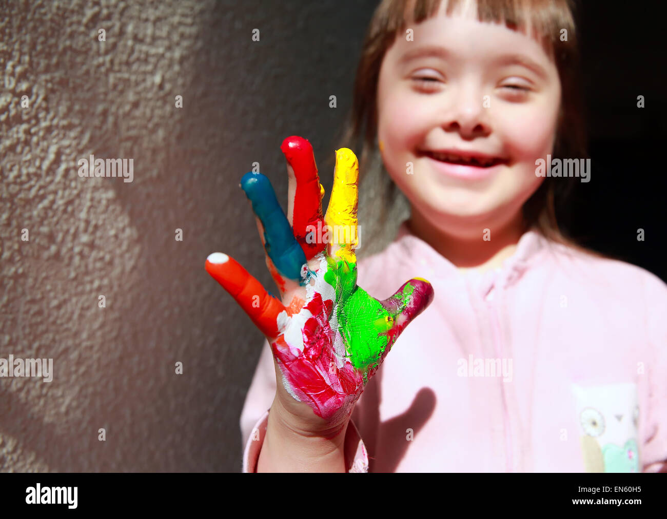 Cute little girl with painted hand Stock Photo - Alamy
