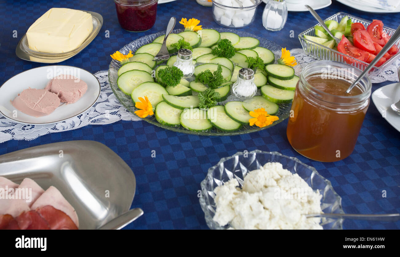 Luncheon table with platters of cold cuts, vegetables and other ...