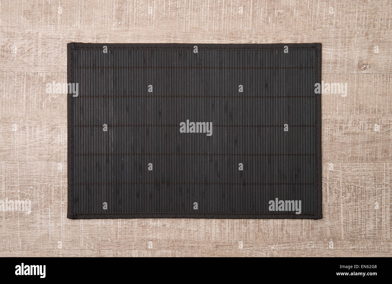 Bamboo place mat on wooden deck table Stock Photo - Alamy