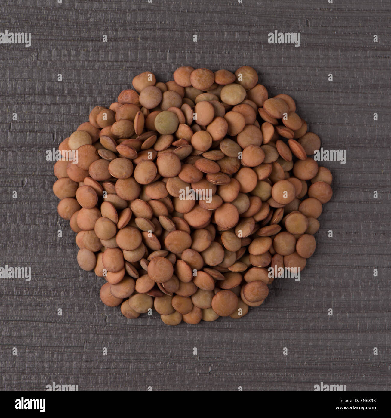 Top view of circle of lentils against grey vinyl background Stock Photo ...