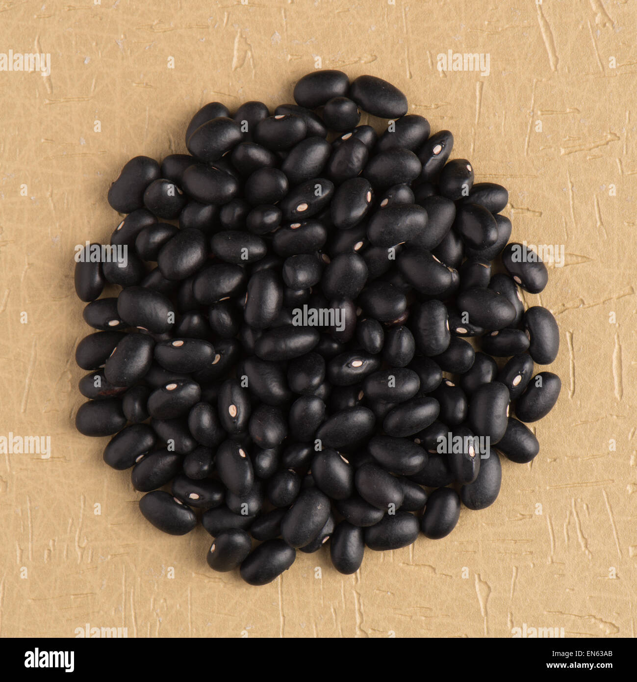 Circle of blue beans on yellow background Stock Photo - Alamy