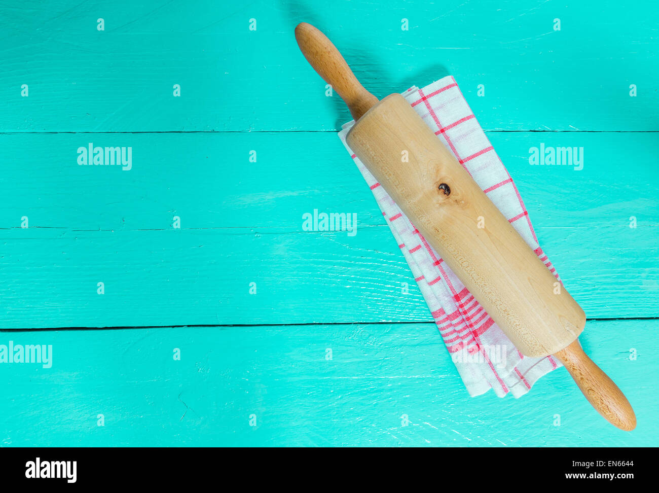Rolling pin and tea towel on turquoise wooden background Stock Photo ...