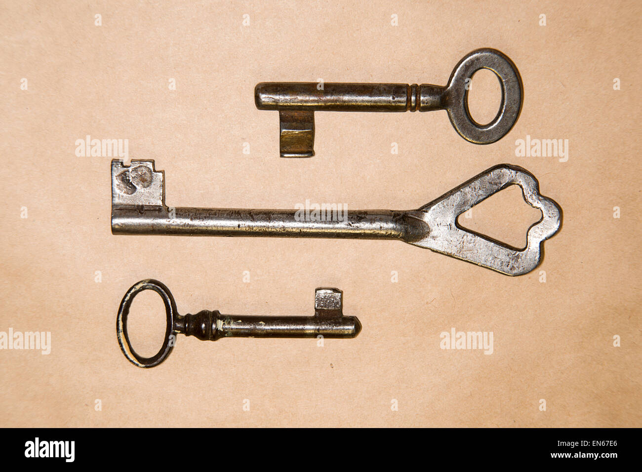 Some vintage keys from the locks on craft paper Stock Photo - Alamy