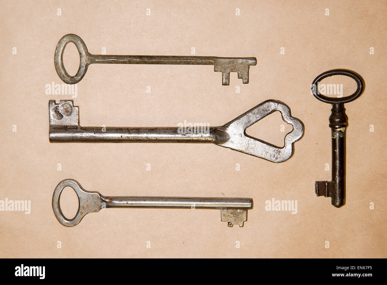 Some vintage keys from the locks on craft paper Stock Photo - Alamy